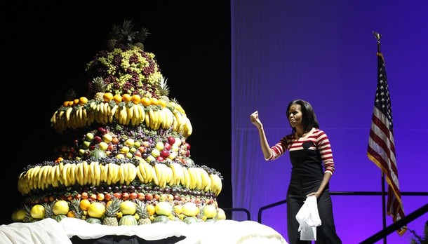 U.S. First Lady Michelle Obama looks at a huge birthday cake made of ...